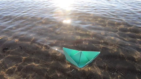 Small green paper boat floats swaying on... | Stock Video | Pond5