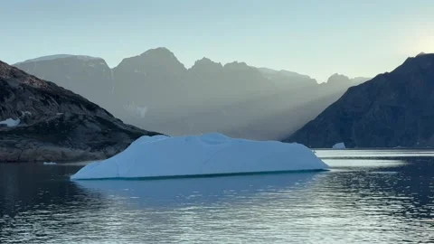 Small iceberg slowly floating in Ø Fjor... | Stock Video | Pond5