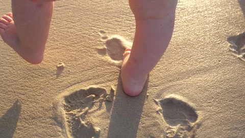 Small legs run on a sandy beach by the w... | Stock Video | Pond5