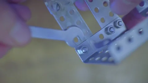 small metal parts are connected with a b... | Stock Video | Pond5