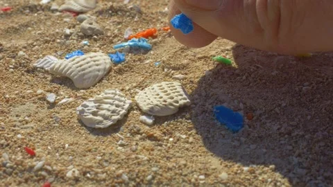 small plastic pieces on sand. microplast... | Stock Video | Pond5