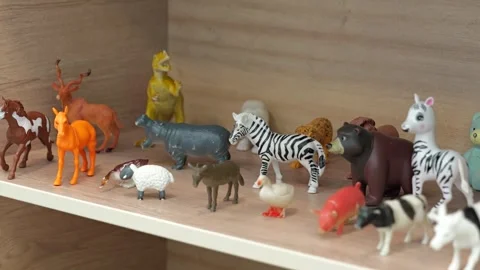 Small plastic toy animals on shelf in ki... | Stock Video | Pond5