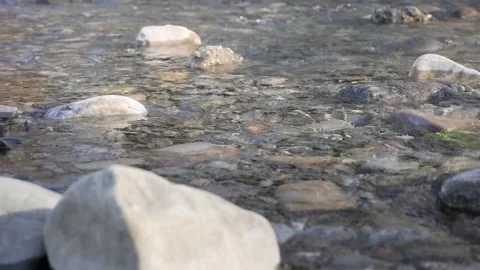 Small river with rocks. Water in a mount... | Stock Video | Pond5