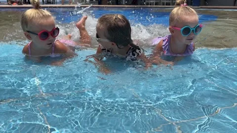 small triplets sisters playing in the po... | Stock Video | Pond5