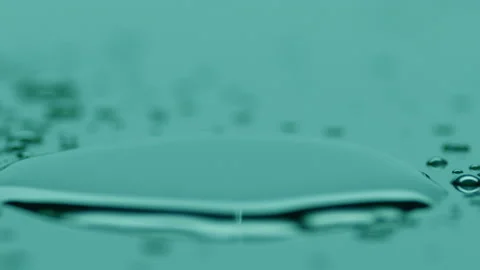 Small water drop drips on big one splash... | Stock Video | Pond5