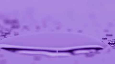 Small water drop drips on big one splash... | Stock Video | Pond5