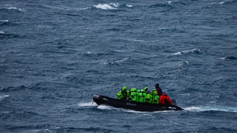 Small zodiac expedition boat with severa... | Stock Video | Pond5