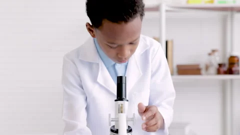 Smart boy student wearing lab coat using... | Stock Video | Pond5