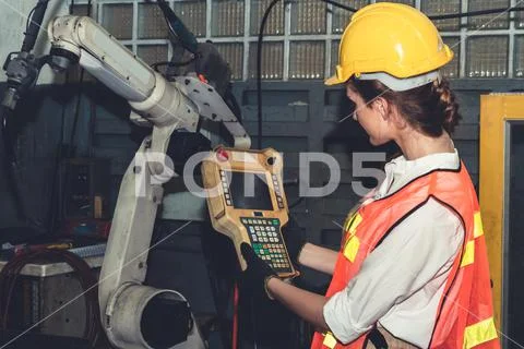Smart factory job worker control robotic arm in manufacturing workshop ...