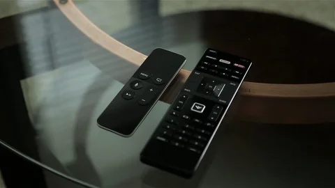 Smart TV Remote Controllers on Coffee Ta... | Stock Video | Pond5