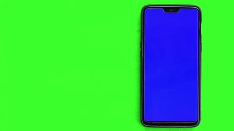 Smartphone with blue display on a green ... | Stock Video | Pond5
