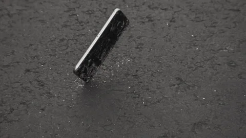 Smartphone falling onto pavement in slow... | Stock Video | Pond5