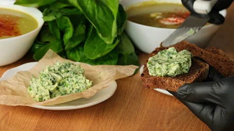 Smear organic butter with herb on bread.... | Stock Video | Pond5