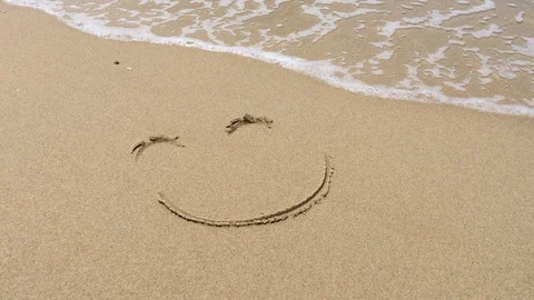a smiley face on the beach | Stock Video | Pond5