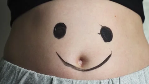 A smiley face is drawn on the girl’s s... | Stock Video | Pond5