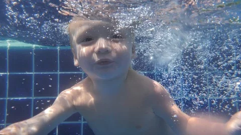 Smiling baby is jumping and diving in th... | Stock Video | Pond5