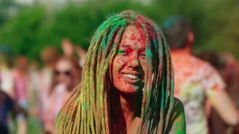 Smiling girl with dreadlocks blowing Hol... | Stock Video | Pond5