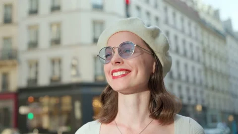 Smiling girl in a white beret on the str... | Stock Video | Pond5