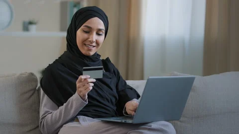 Smiling islamic girl customer in hijab s... | Stock Video | Pond5