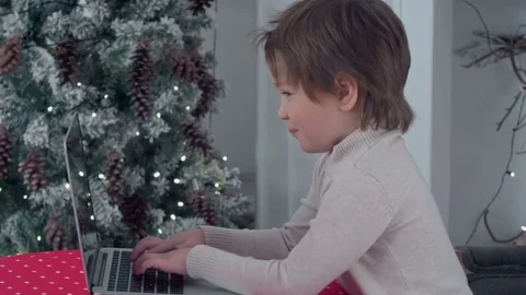 Smiling little boy typing letter to Sant... | Stock Video | Pond5