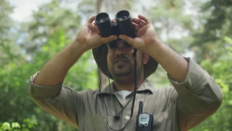 Smiling Male Park Ranger Looking through... | Stock Video | Pond5