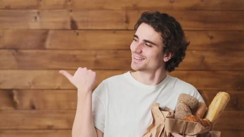 The smiling man with bread in his hands ... | Stock Video | Pond5