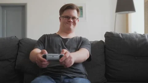 A smiling man with down syndrome is play... | Stock Video | Pond5