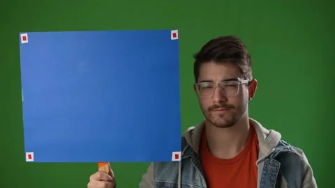 A smiling man holds a green screen chrom... | Stock Video | Pond5