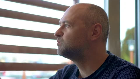 Smiling man sitting on bar counter and e... | Stock Video | Pond5