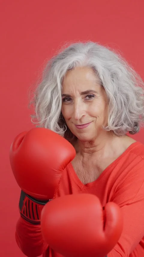 Smiling mature woman in fighting pose we... | Stock Video | Pond5