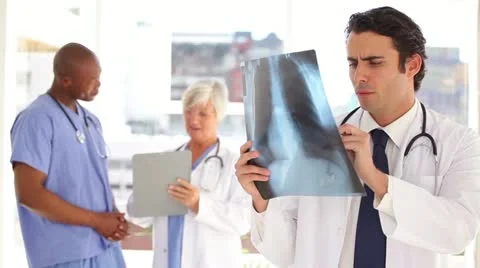 Smiling medical team standing behind a d... | Stock Video | Pond5