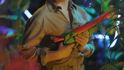 smiling modern child with toy gun in vir... | Stock Video | Pond5