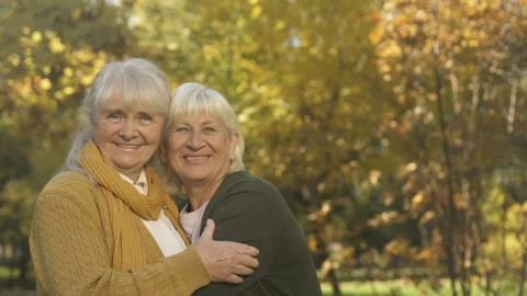 Smiling old women hugging and looking in... | Stock Video | Pond5