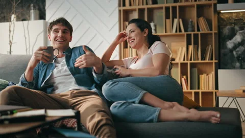 Smiling pair talking couch holding cups ... | Stock Video | Pond5
