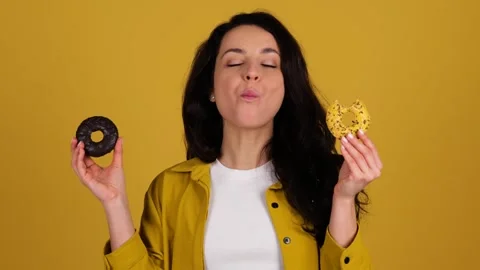 Smiling pretty lady choosing between two... | Stock Video | Pond5