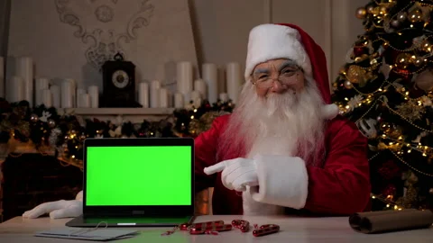 Smiling Santa Claus points finger at lap... | Stock Video | Pond5