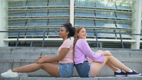 Smiling teen girls sitting back at acade... | Stock Video | Pond5
