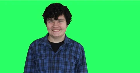 Smiling teenage boy with green screen ba... | Stock Video | Pond5