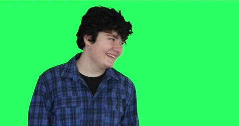 Smiling teenage boy with green screen ba... | Stock Video | Pond5