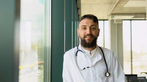 Smiling young Arabian male doctor in whi... | Stock Video | Pond5