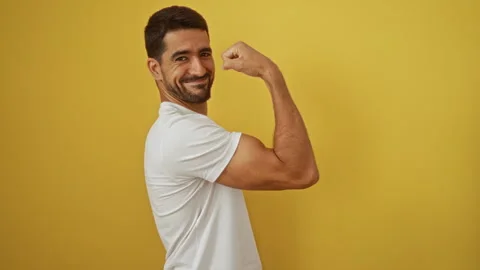 Smiling young hispanic man flexing his a... | Stock Video | Pond5