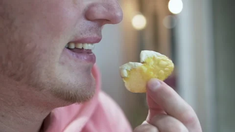 Smiling young man eating chips, unhealth... | Stock Video | Pond5