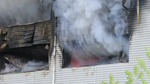 Smoke and fire from a window in a wareho... | Stock Video | Pond5