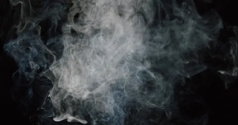 Smoke billows up into frame against blac... | Stock Video | Pond5
