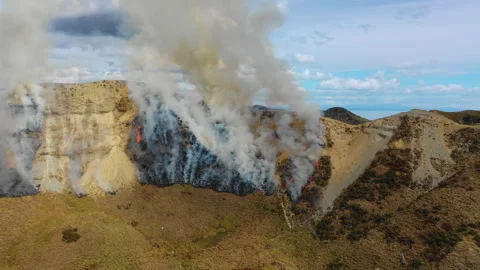 Smoke from a bushfire burns up a mountai... | Stock Video | Pond5
