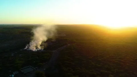Smoke plume rises from burn pit at sunse... | Stock Video | Pond5