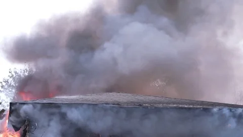 Smoke rises from a dangerous house on fi... | Stock Video | Pond5