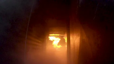 Smoky, dark hallway with fire burning in... | Stock Video | Pond5