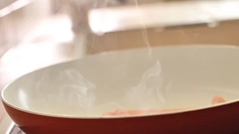 Smoky fried bacon.Hand putting strips of... | Stock Video | Pond5