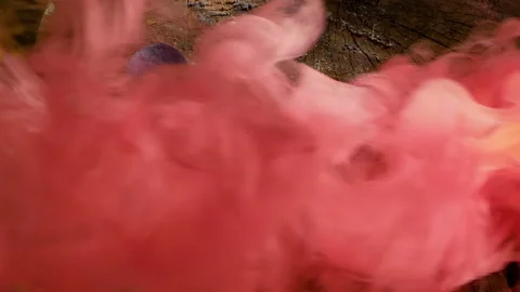 Smoldering red smoke bomb. Red smoke bac... | Stock Video | Pond5